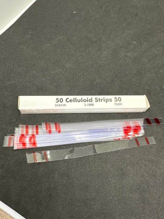 Celluloid Strip > a clear plastic strip used as a matrix when inserting ...