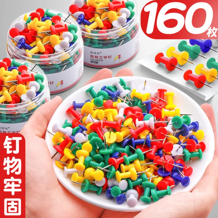 2 barrel thumbtacks are nailed with colored I-shaped nails, small ...