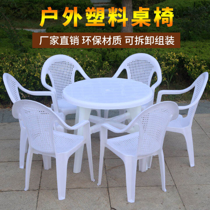 Outdoor food stalls night market barbecue plastic beach tables and ...