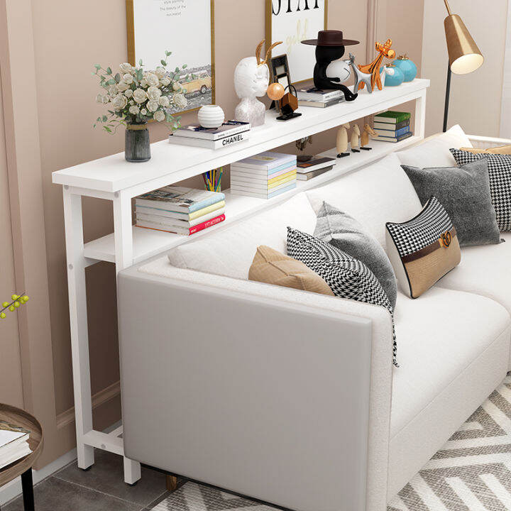 The long shelf behind the living room sofa is simple against the wall ...