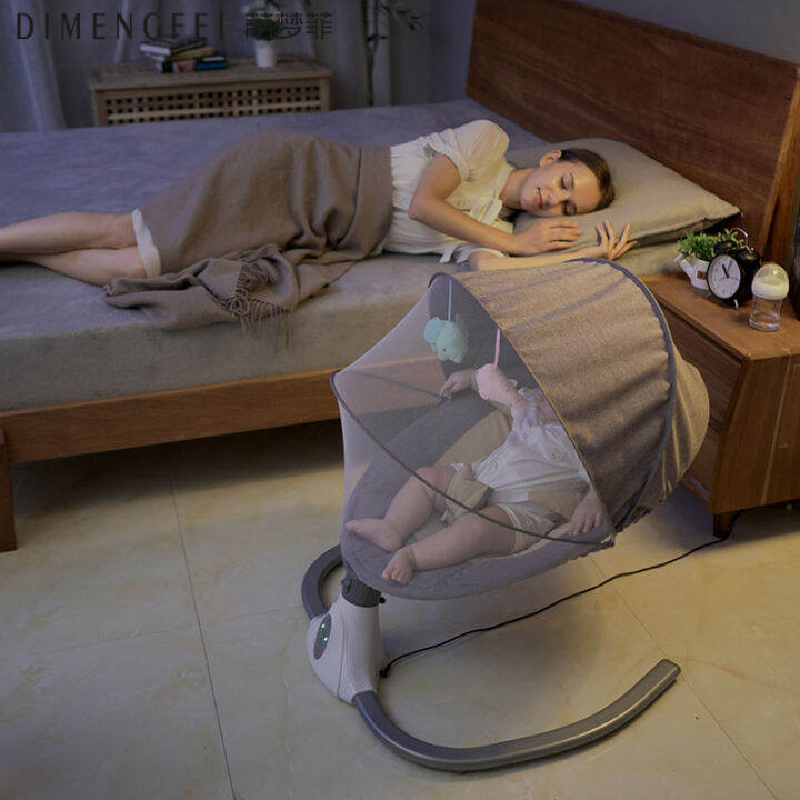 The newborn baby sleeps in an electric soothing rocking chair, and the ...
